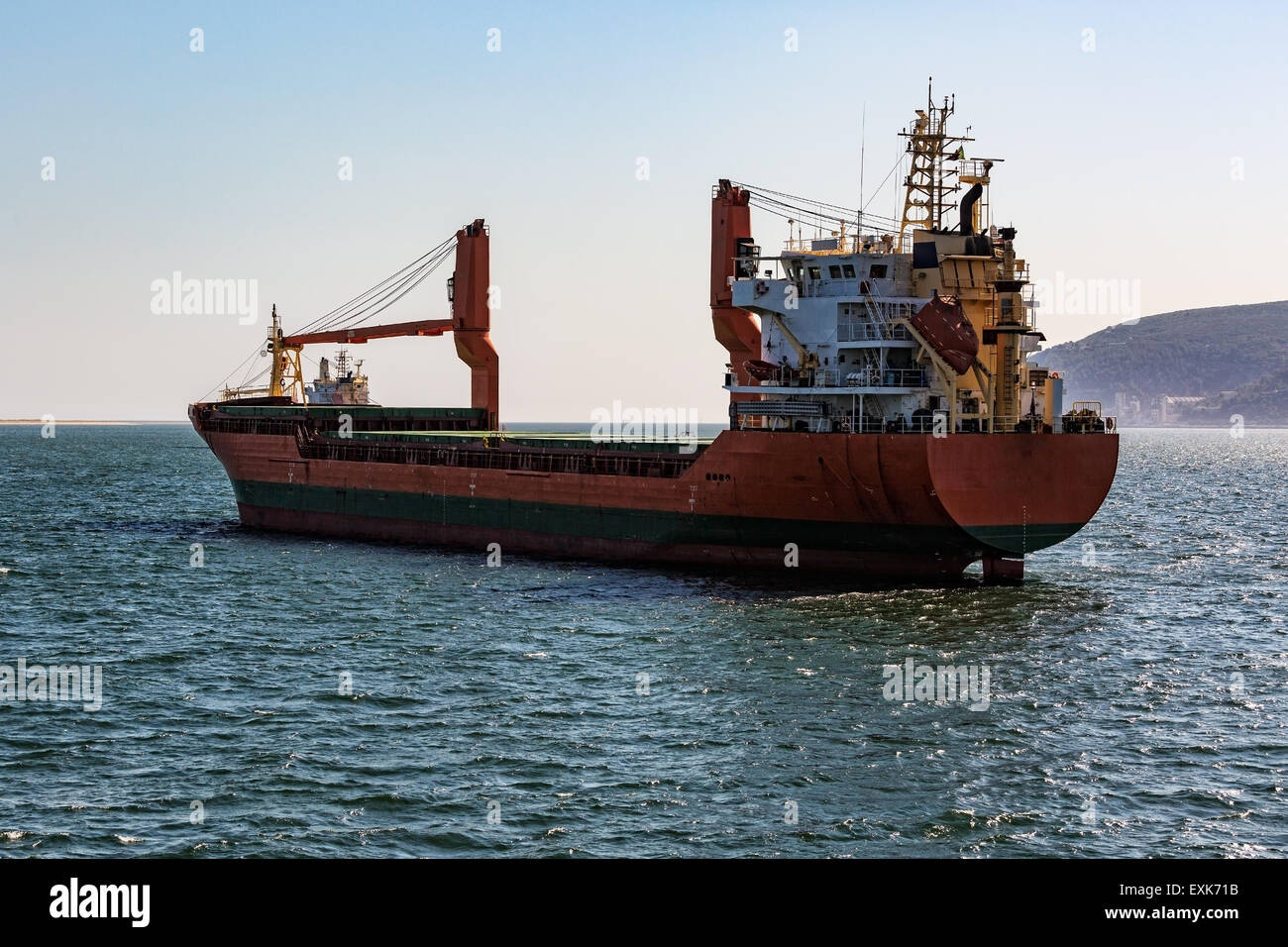 Cargo Ship Sailing in Ocean, sunny day Stock Photo - Alamy