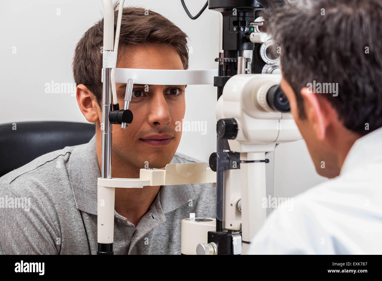 Man checking his eyes Stock Photo - Alamy