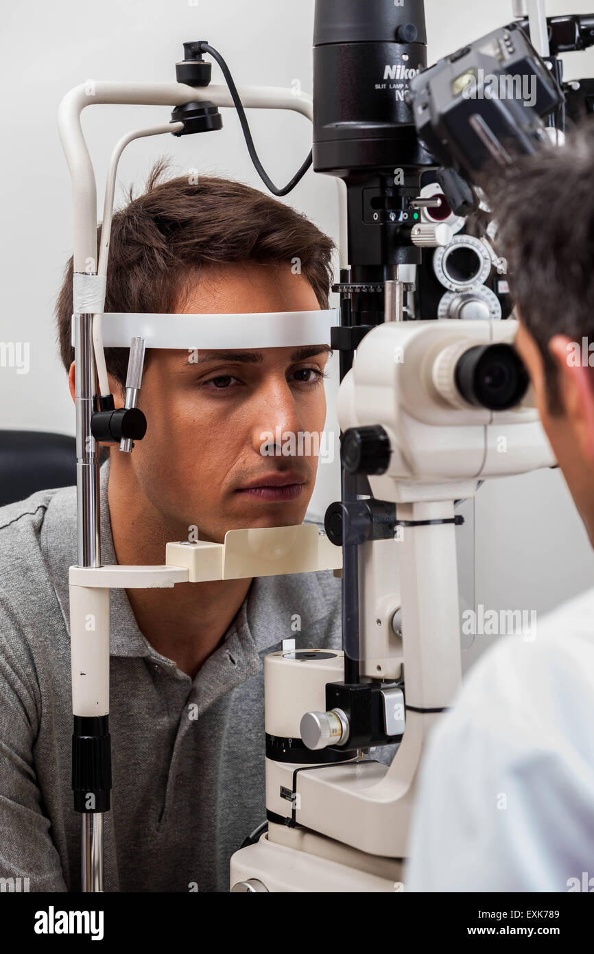 Man checking his eyes Stock Photo - Alamy