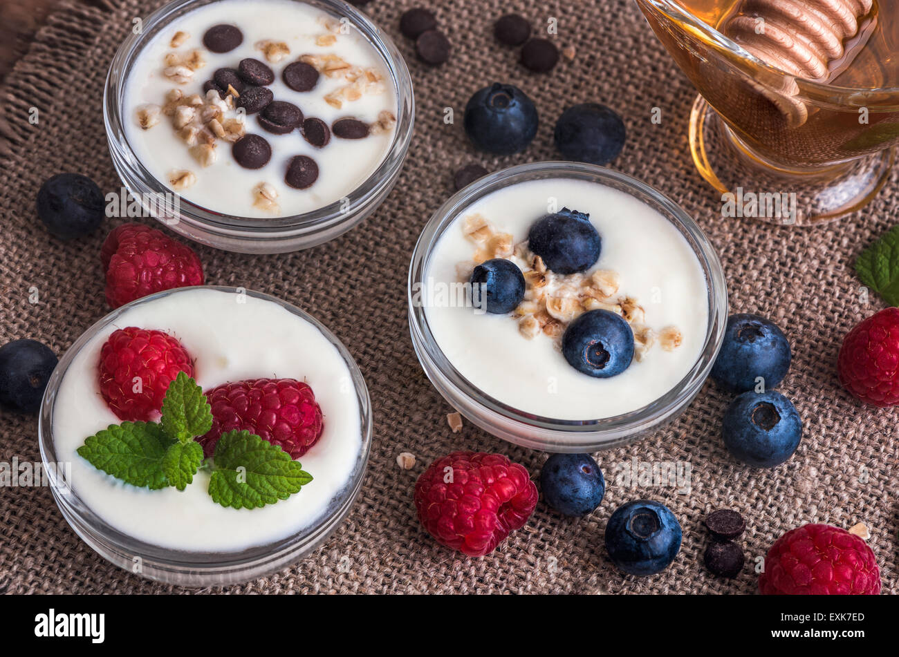 Three Little Bowls Full of Healthy Yogurt with Fruit or Chocolate and ...