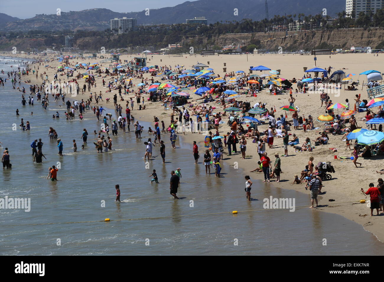 A large group of people gathered at Santa Monica Beach in California ...