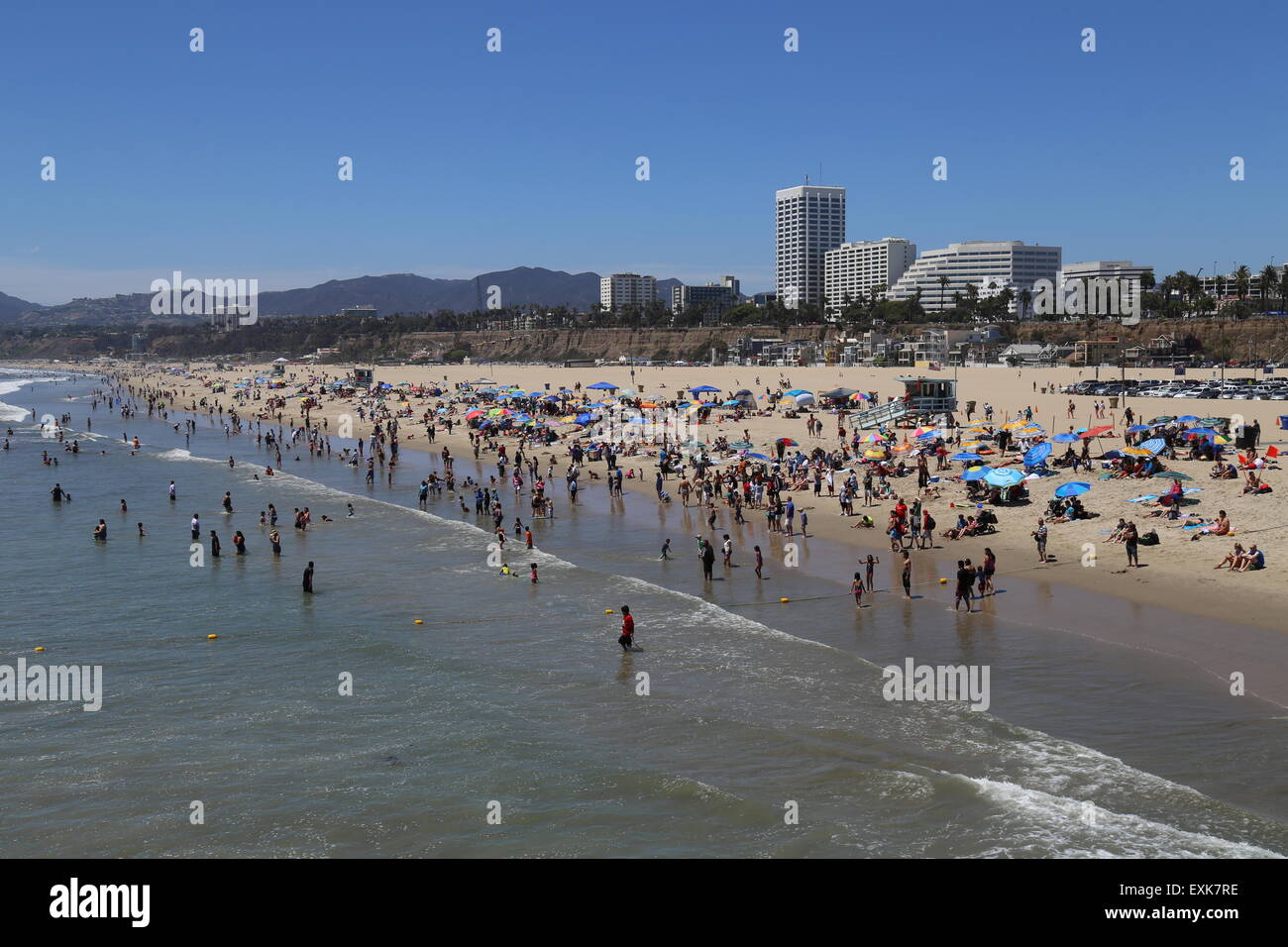 A large group of people gathered at Santa Monica Beach in California ...