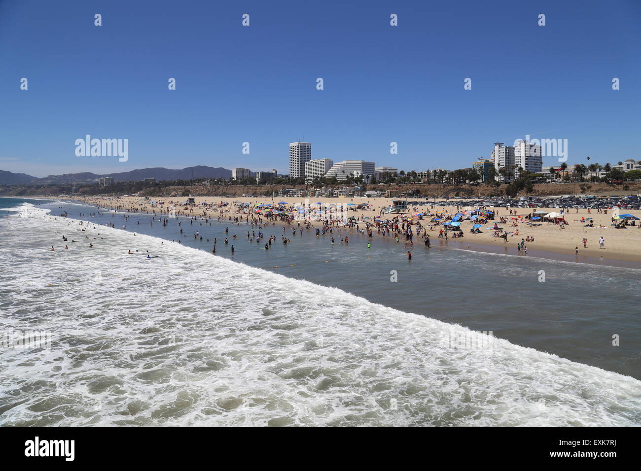 A large group of people gathered at Santa Monica Beach in California ...