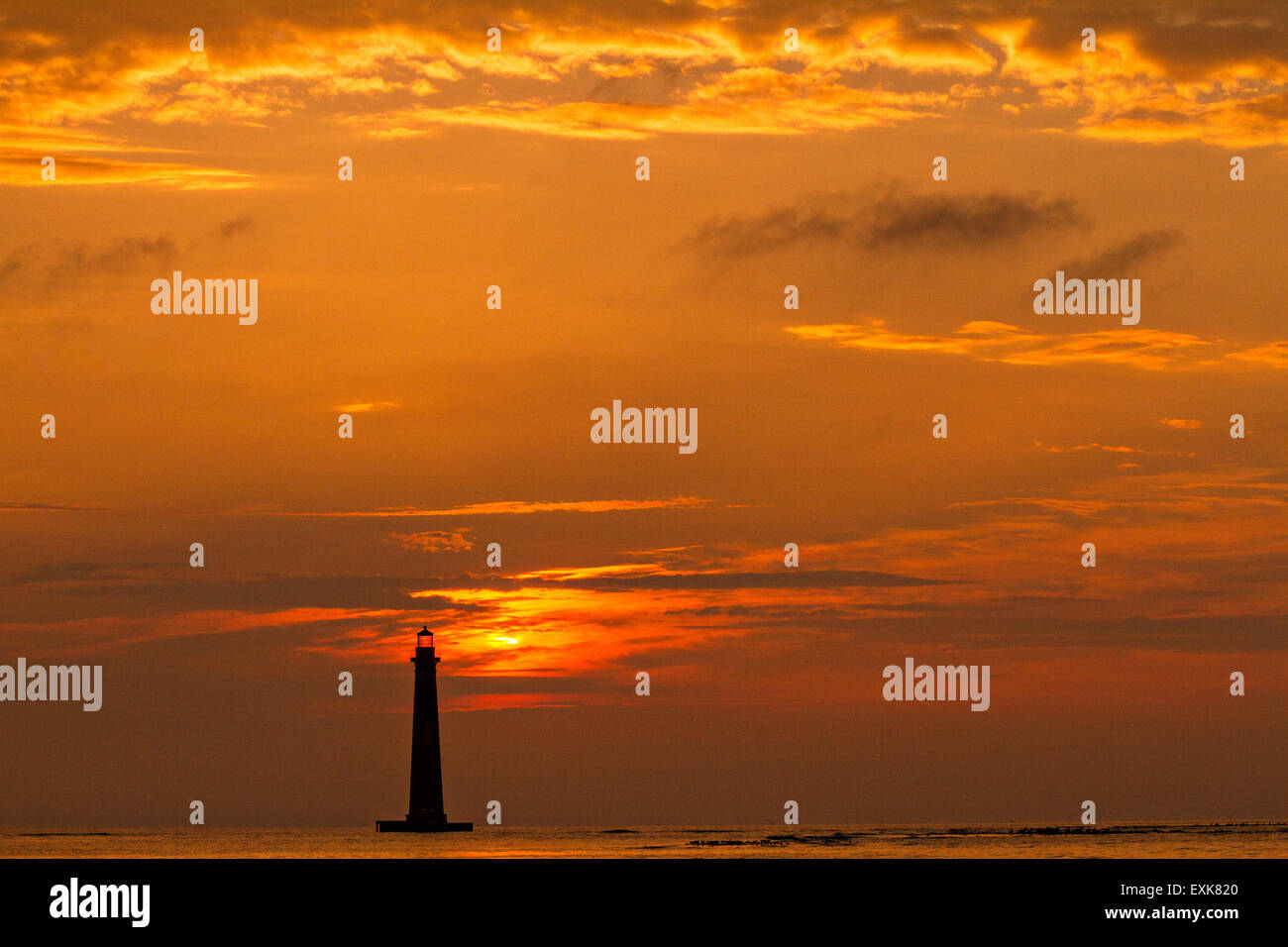 Sunrise over Morris Island Light house seen from Folly Beach July 13 ...