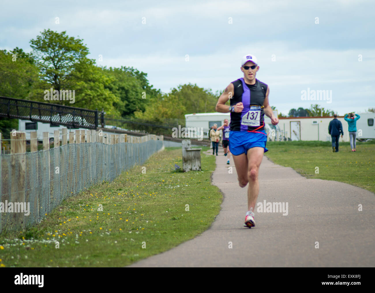Runner approaching finish line Stock Photo - Alamy