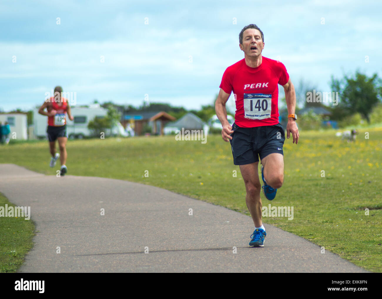 Male runner approaching the finish line Stock Photo - Alamy