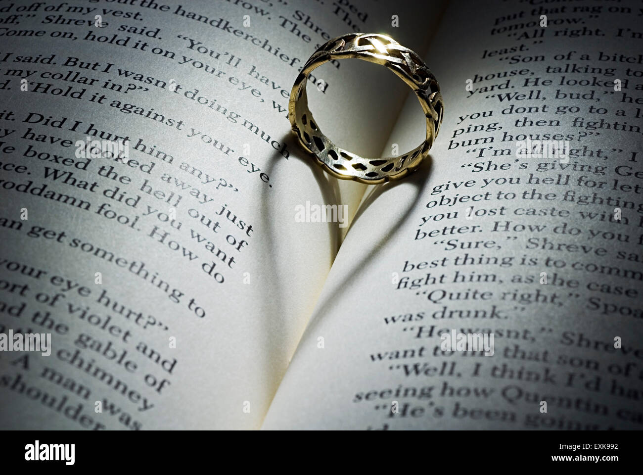 Ring lying on an open book with heart-shaped shadow Stock Photo - Alamy