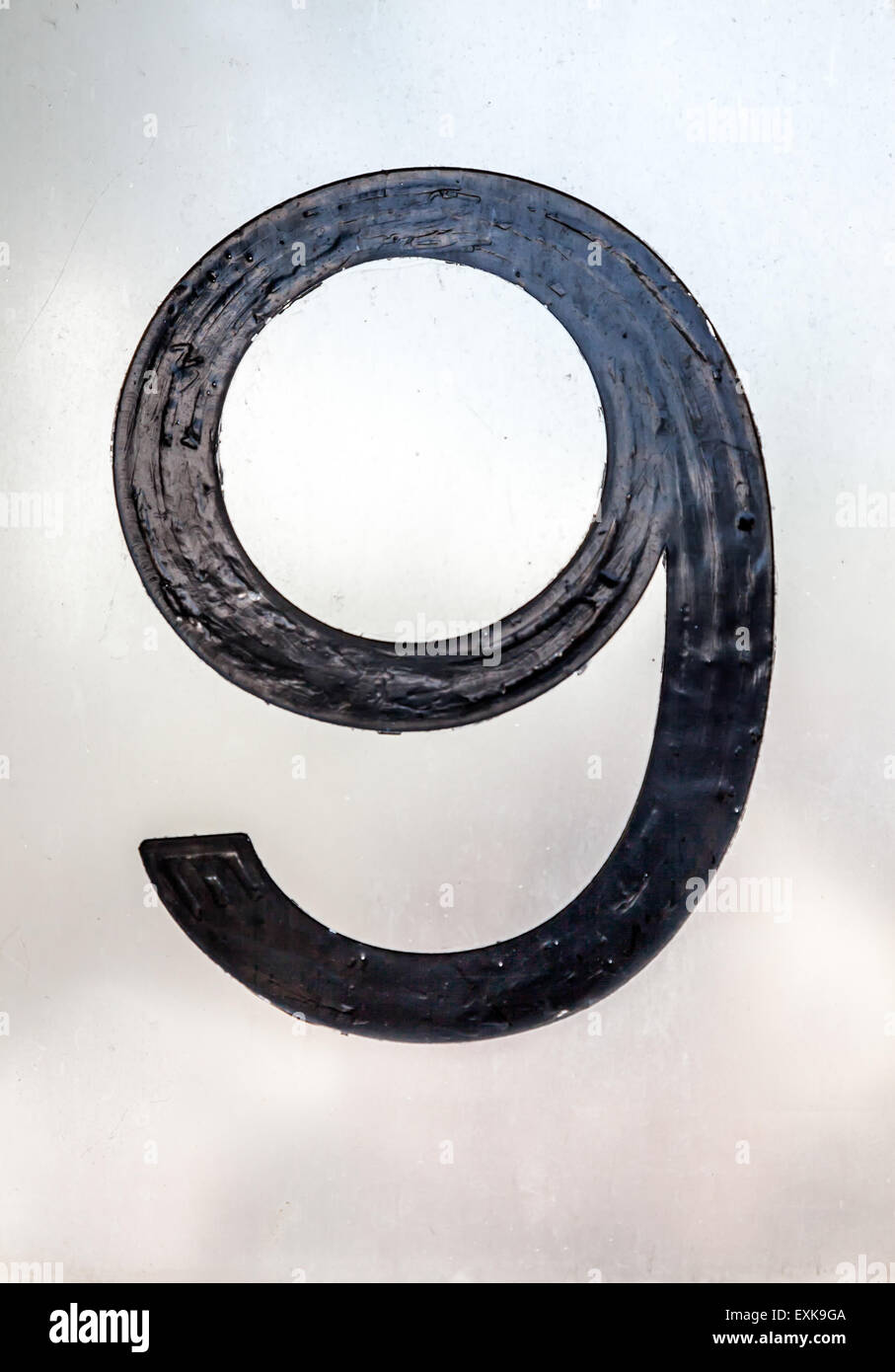 Number nine painted on metal metal plaque Stock Photo - Alamy