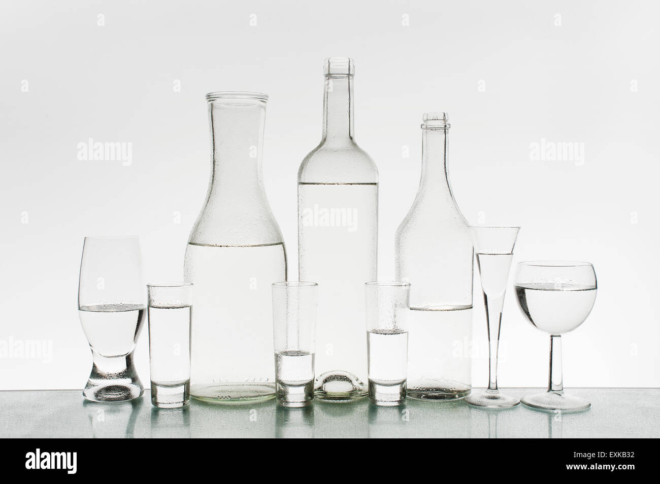 Glassware with clean water on the light background Stock Photo - Alamy