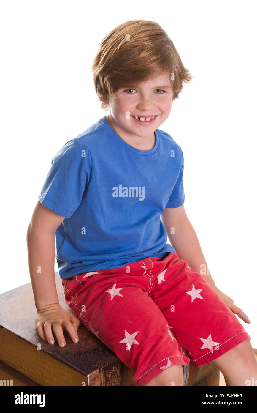 Young boy sitting and smiling at the camera Stock Photo - Alamy