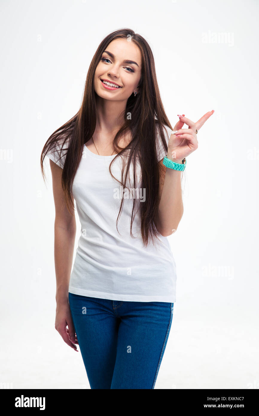 Smiling beautiful woman pointing finger away isolated on a white ...