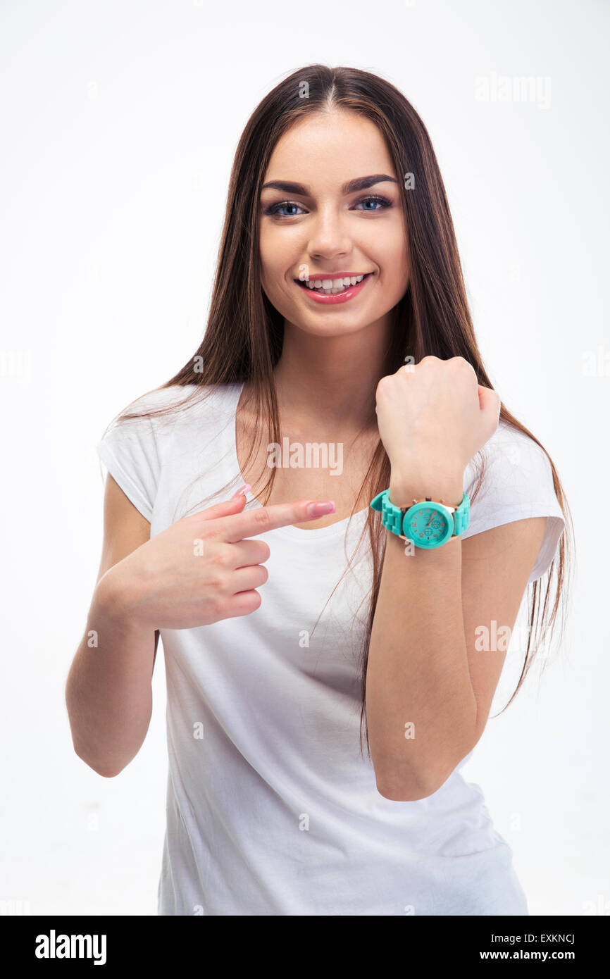 Happy young girl pointing finger at her watch isolated on a white ...
