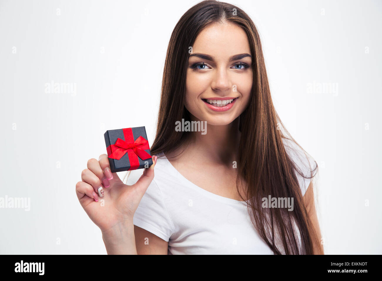 Happy young woman holding small gift box isolated on a white background ...