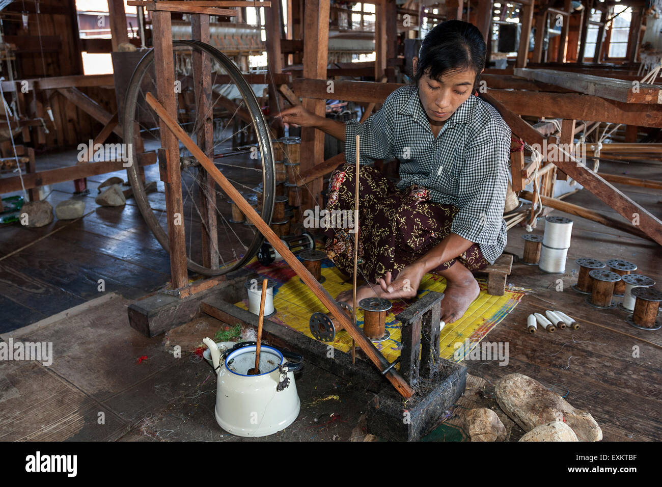 Local woman weaving threads from the stems of the lotus plant, lotus ...