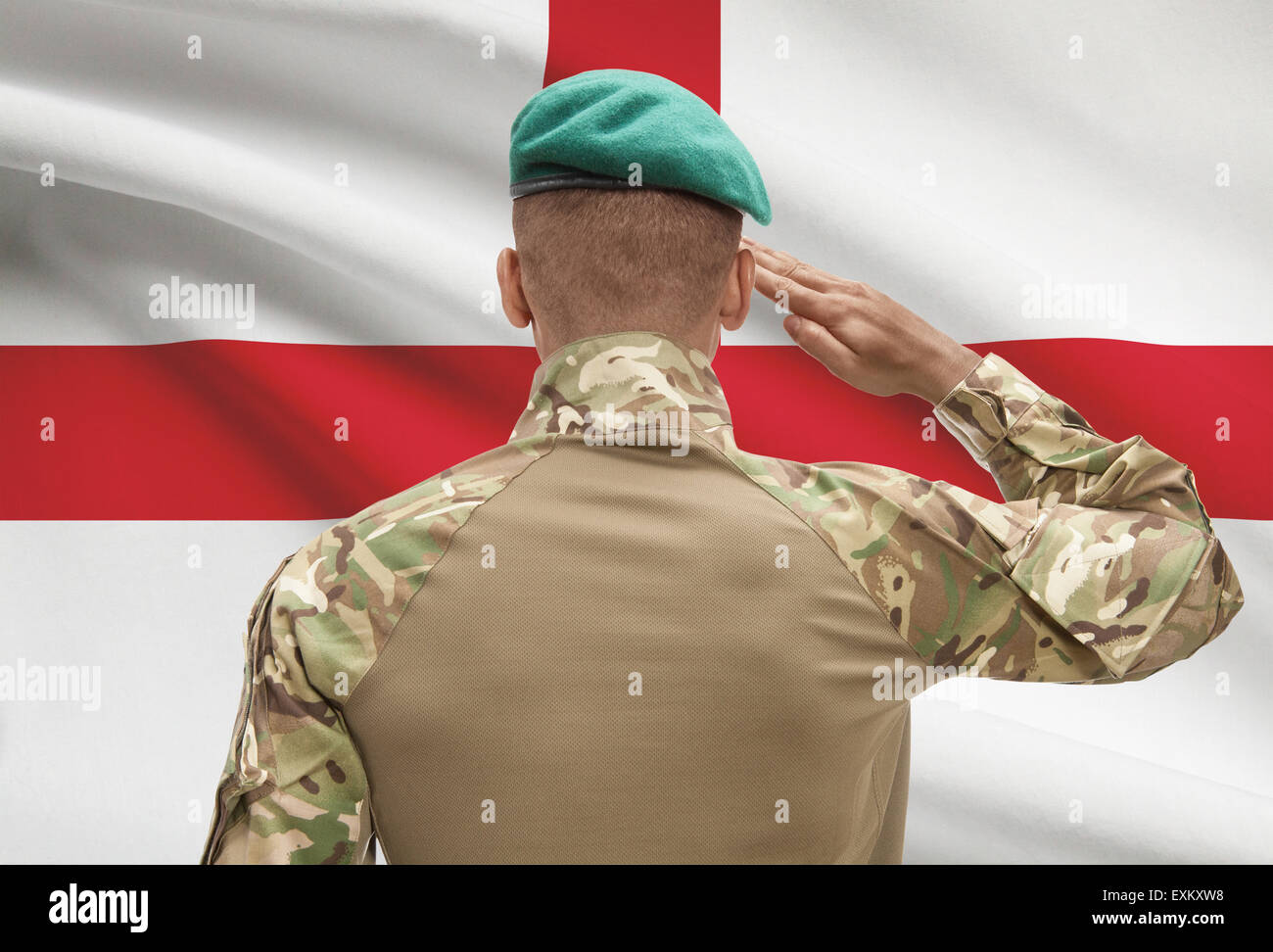 Dark-skinned soldier in hat facing national flag series - England Stock ...