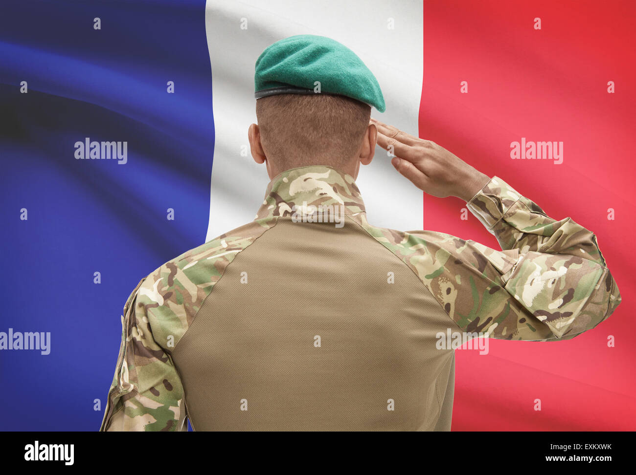 Dark-skinned soldier in hat facing national flag series - France Stock ...