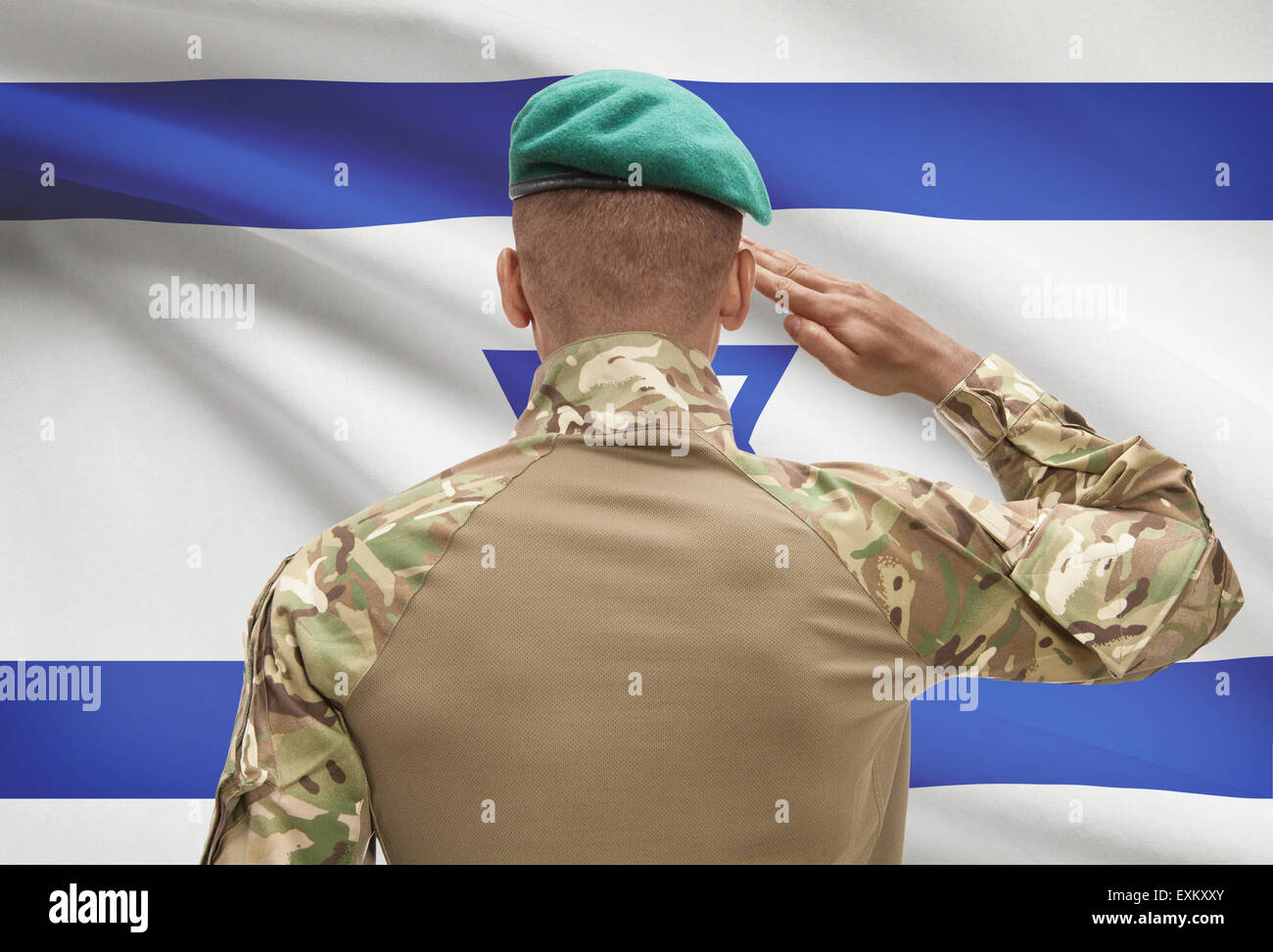 Dark-skinned soldier in hat facing national flag series - Israel Stock ...