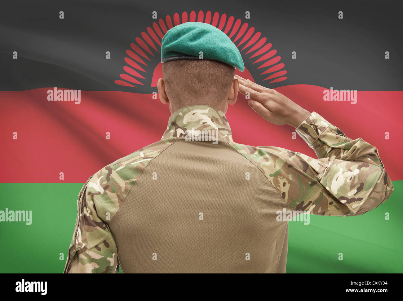 Dark-skinned soldier in hat facing national flag series - Malawi Stock ...