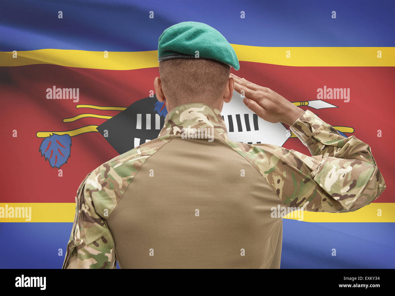 Dark-skinned soldier in hat facing national flag series - Swaziland ...