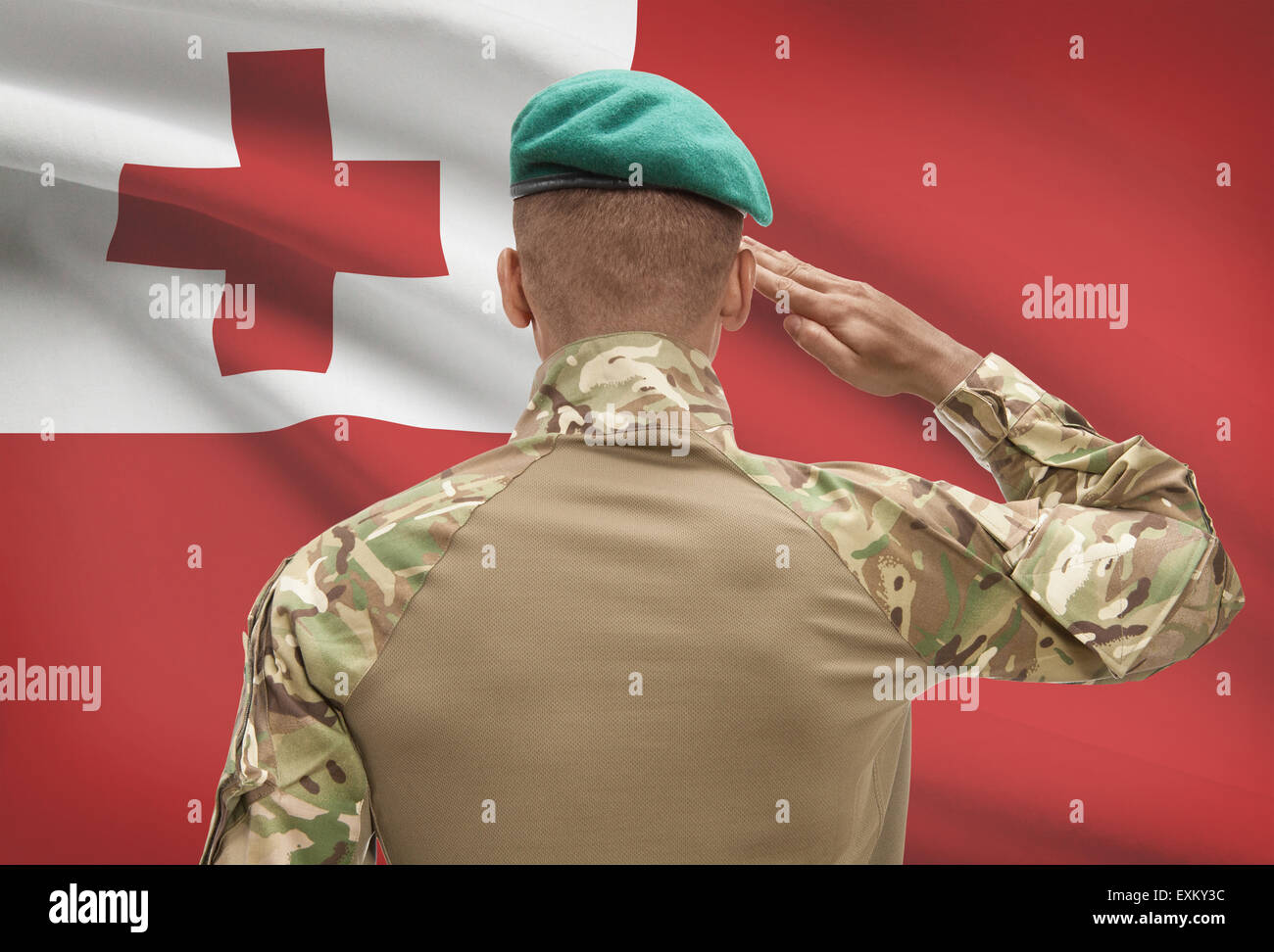Dark-skinned soldier in hat facing national flag series - Tonga Stock ...