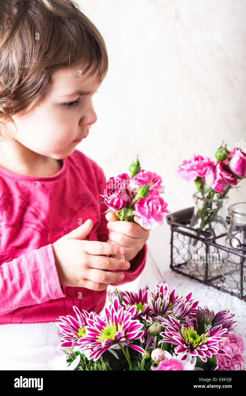 Child smelling rose hi-res stock photography and images - Alamy