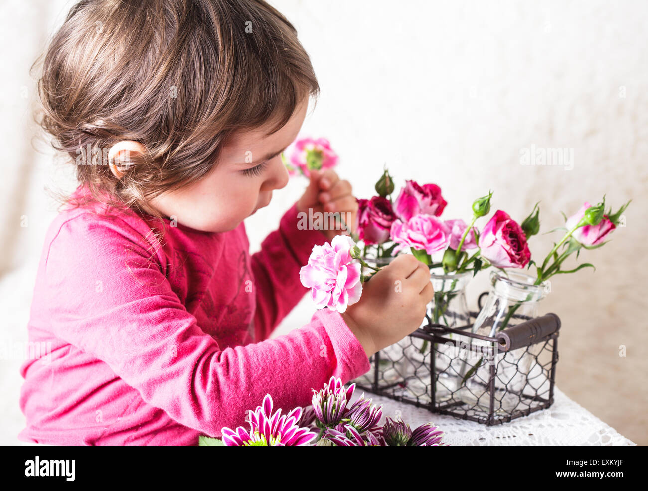 Child smelling rose hi-res stock photography and images - Alamy