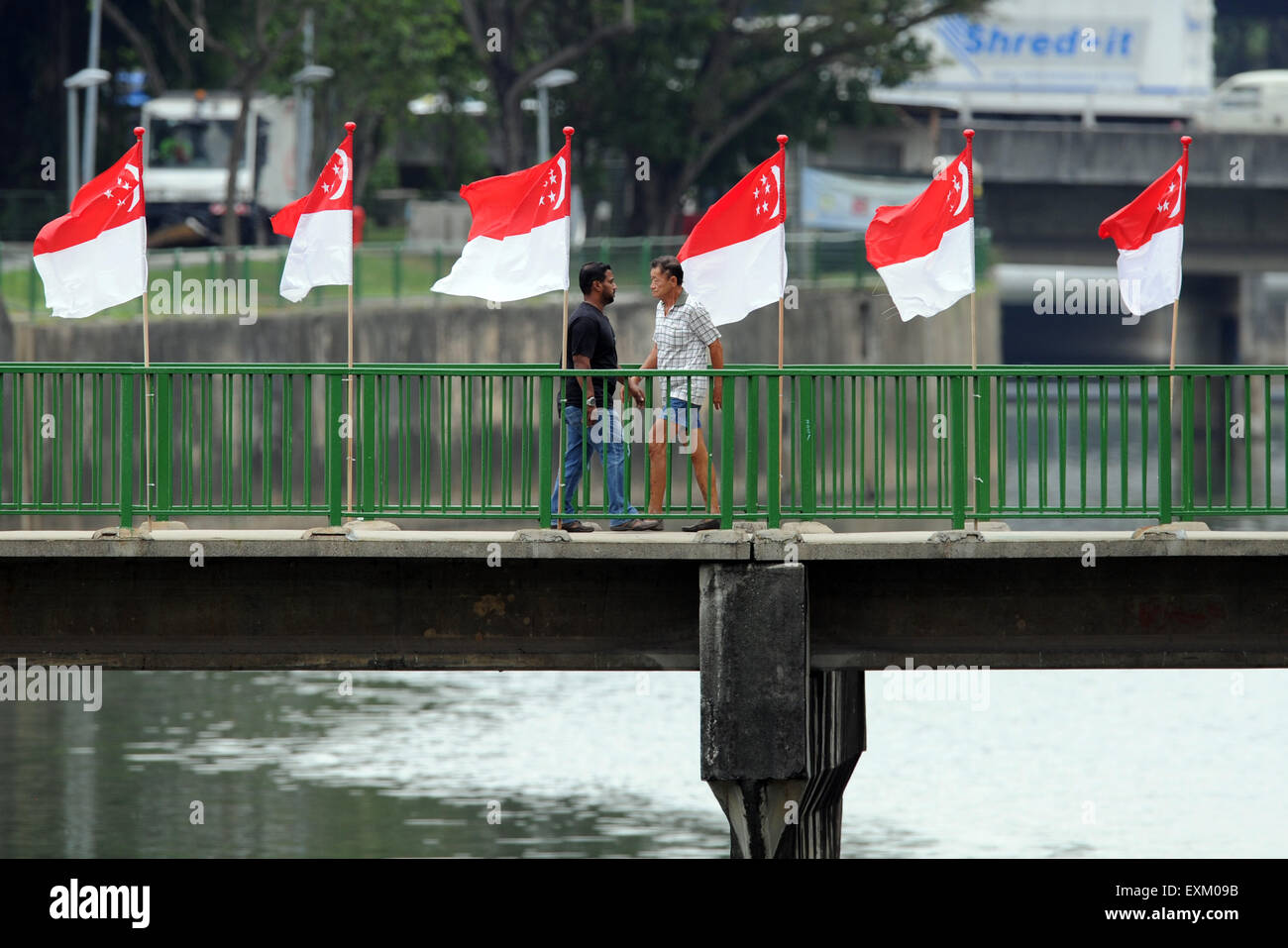 Singapore. 15th July, 2015. People walk on a pedestrian bridge lined ...