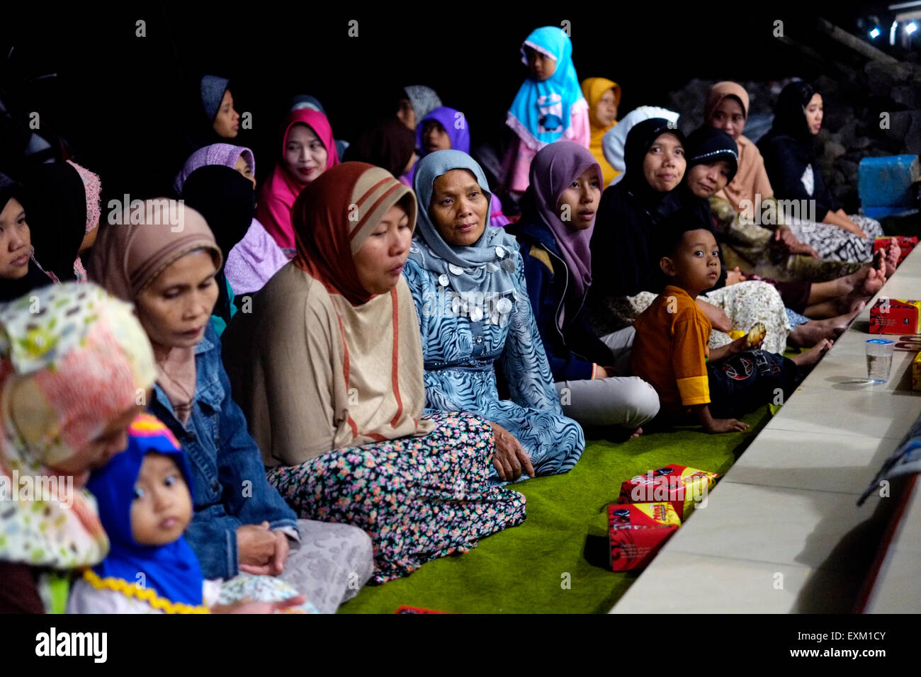 local women gather for a night meeting at a small village mosque during ...