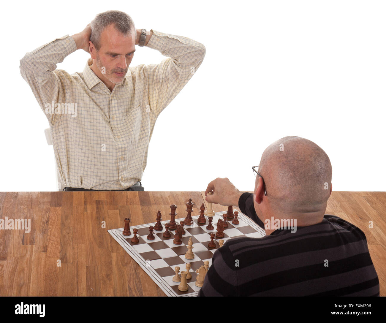 One chess player checkmates the other; isolated on white Stock Photo ...