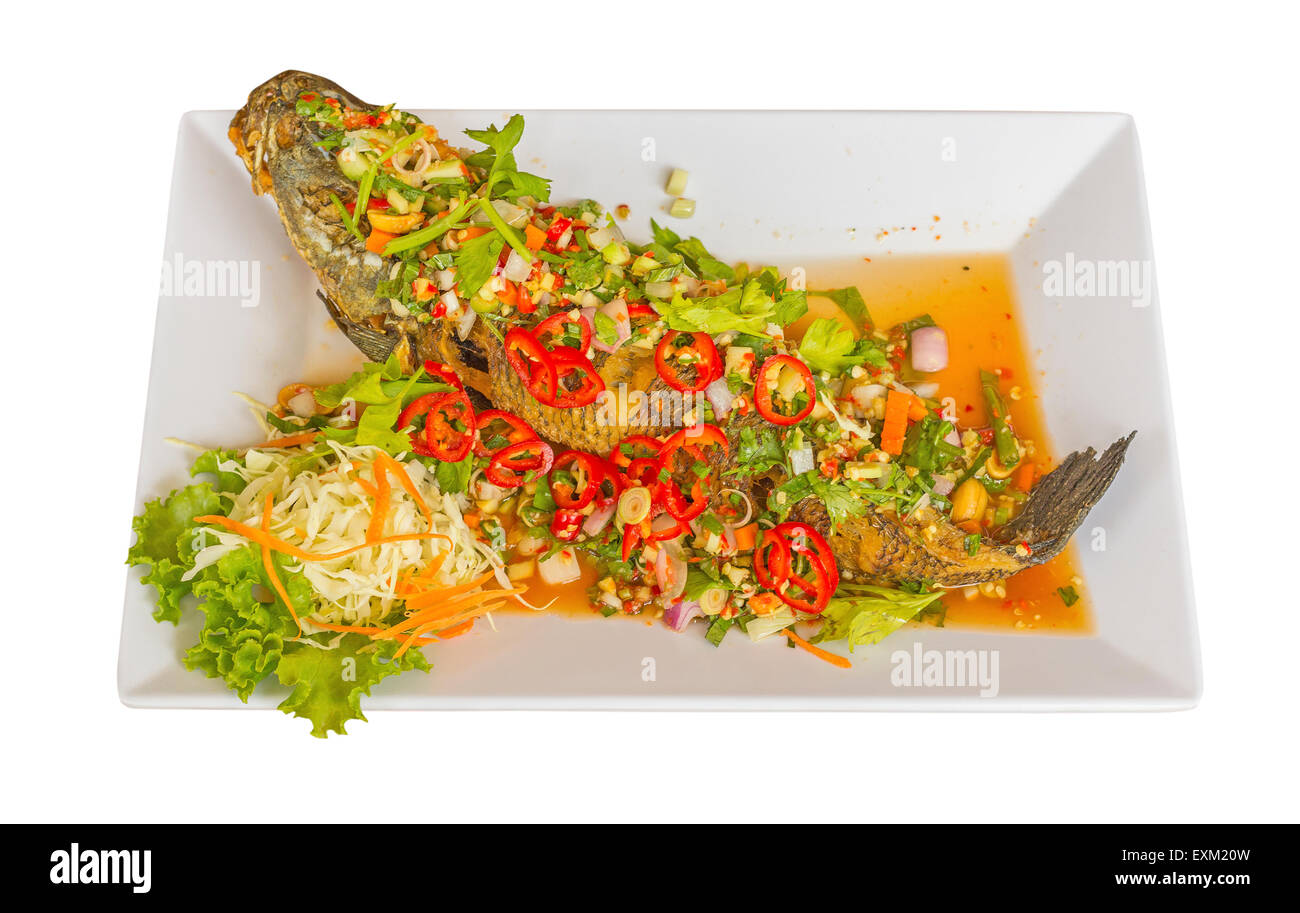 Deep fried snakehead fish serve with herb and spicy sauce isolated on ...