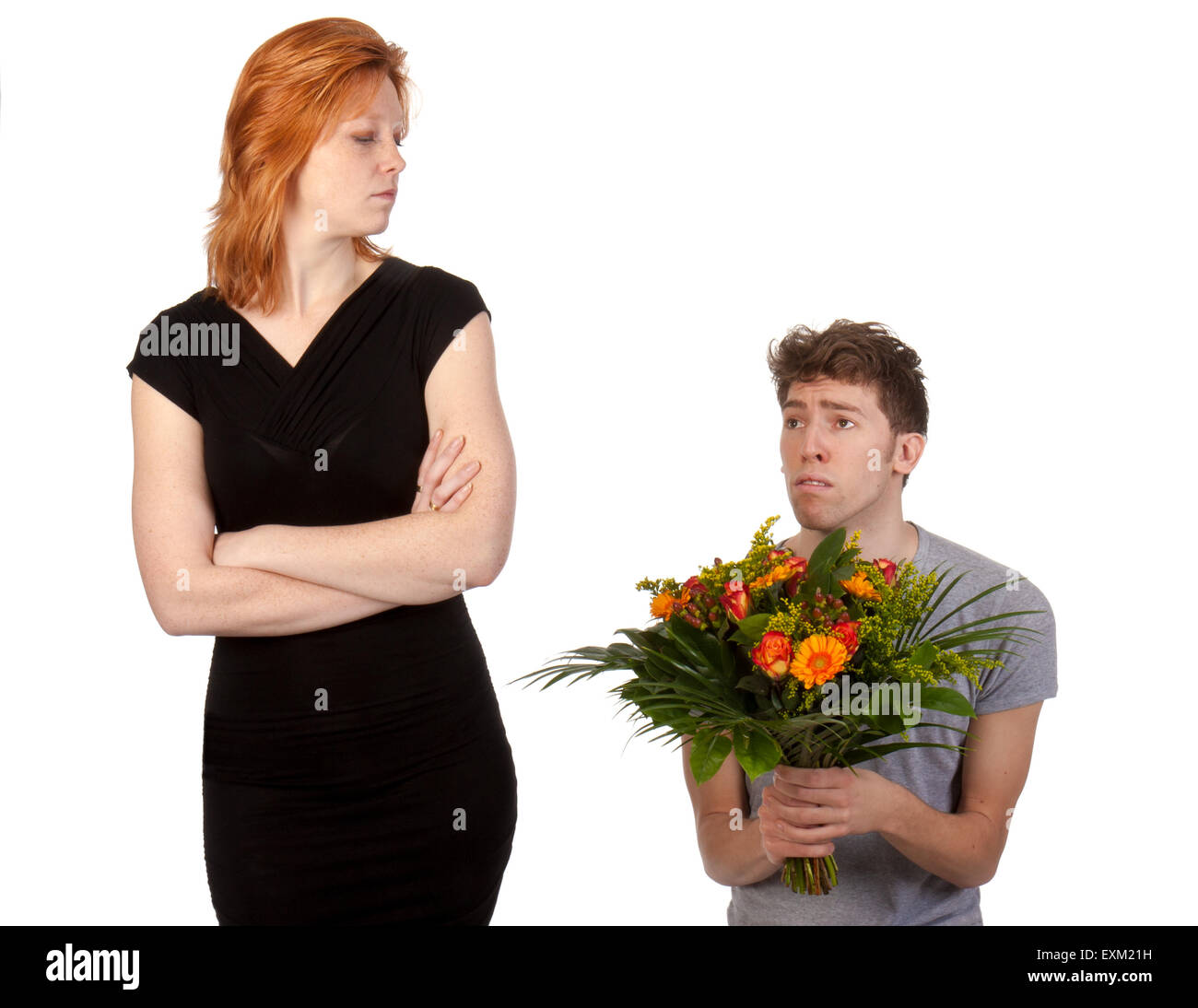 Young boy offering a bunch of flowers to his angry girlfriend Stock ...