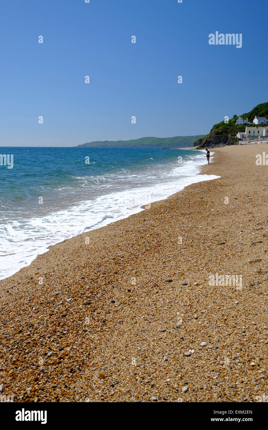 Torcross, Devon, UK. Man standing on shingle beach at shore edge Stock ...