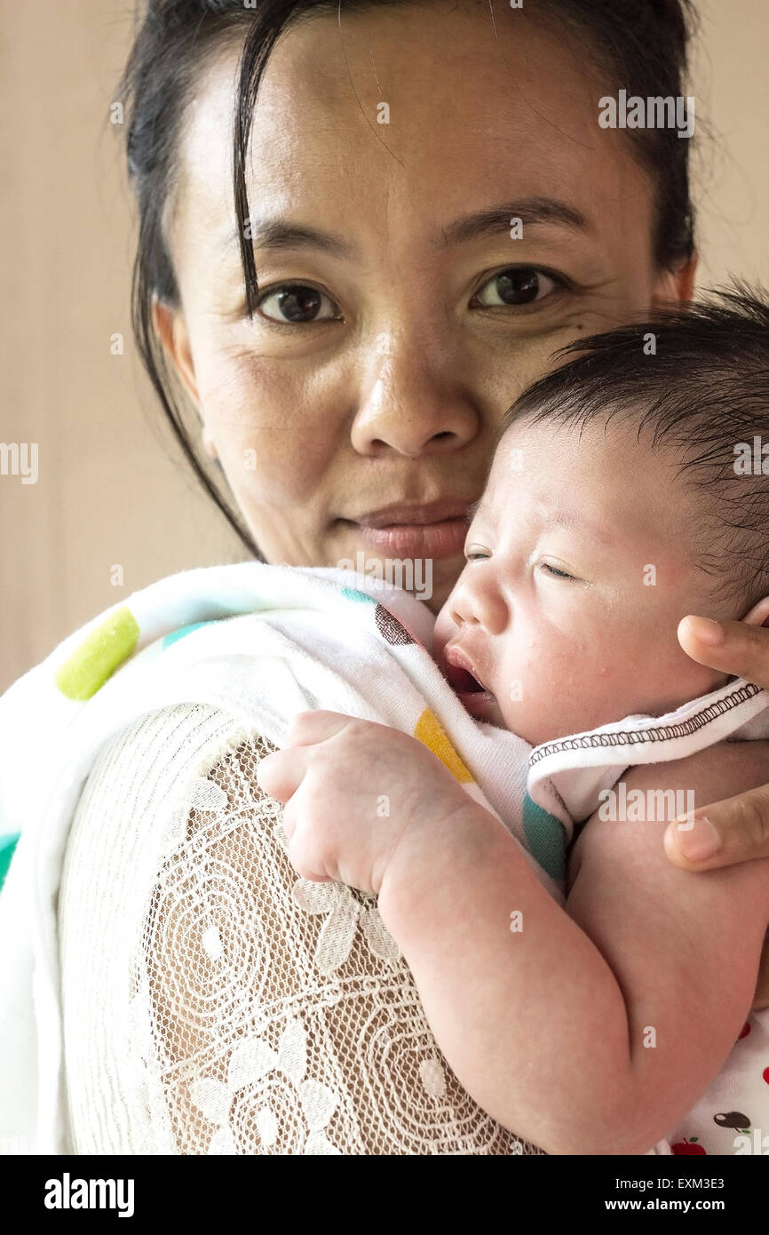 Asian Thai mother holding sweet little newborn baby boy Stock Photo - Alamy