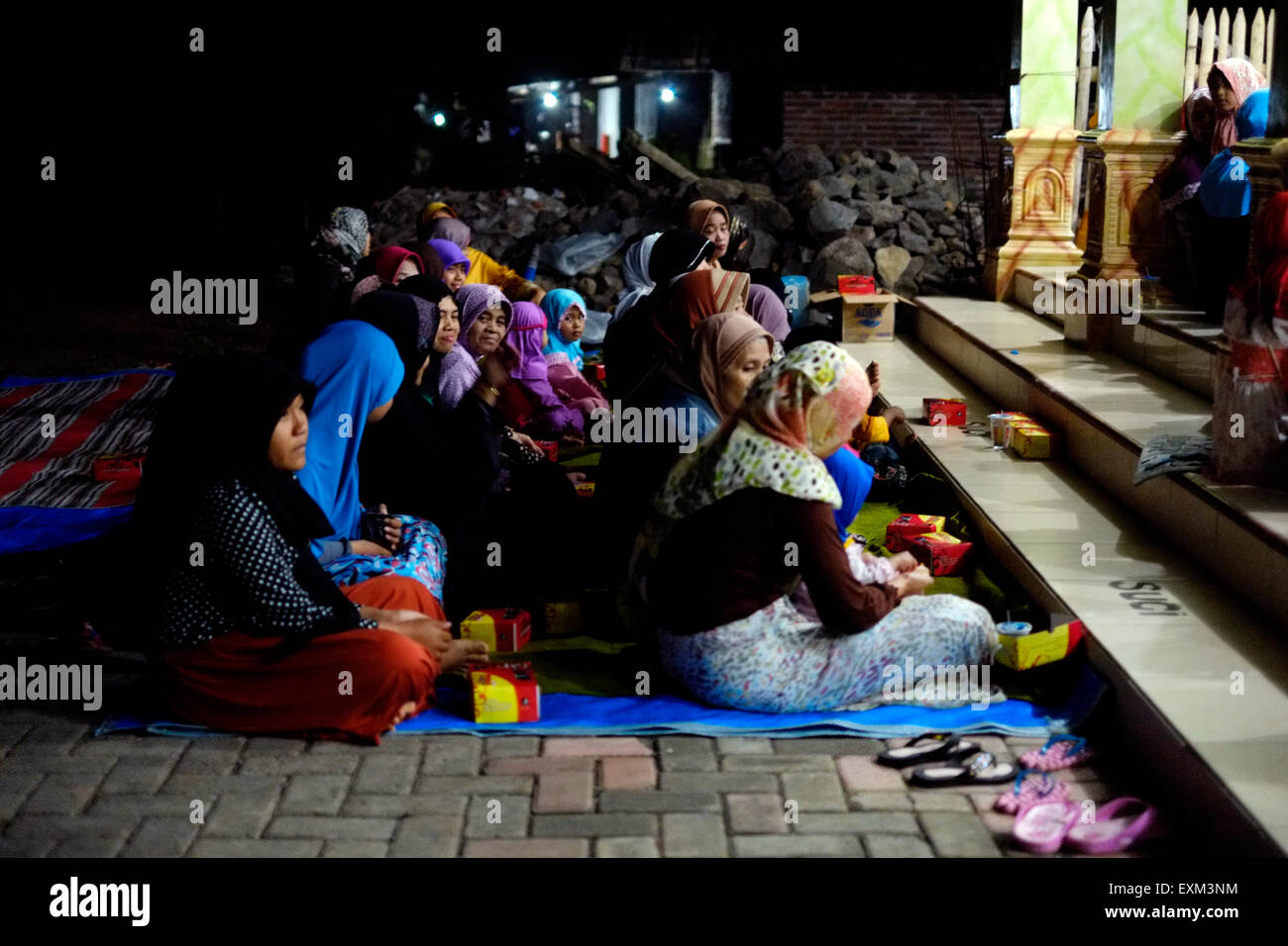 local women attend a night meeting at a small village mosque during ...