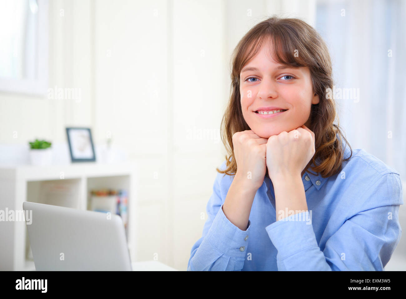 View of a young smiling business woman at work Stock Photo - Alamy