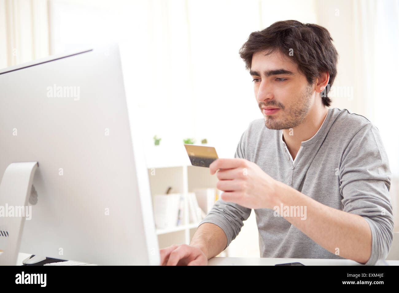 Young man credit card computer hi-res stock photography and images - Alamy