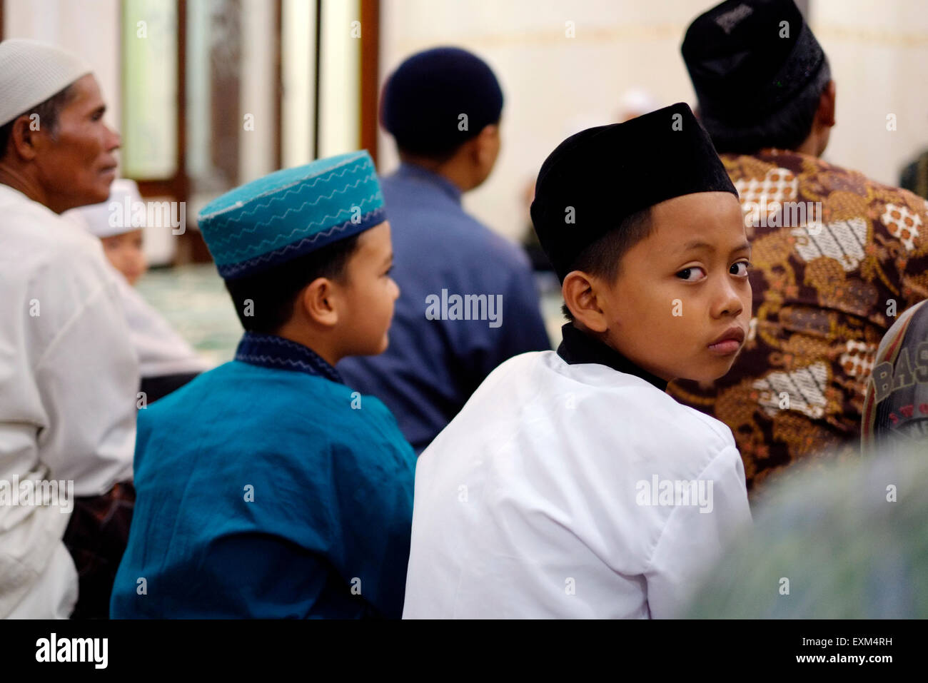 local children at a night meeting at a small village mosque during ...