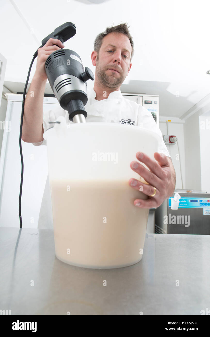 making ice cream in a professional kitchen, mixing it, adding the ...