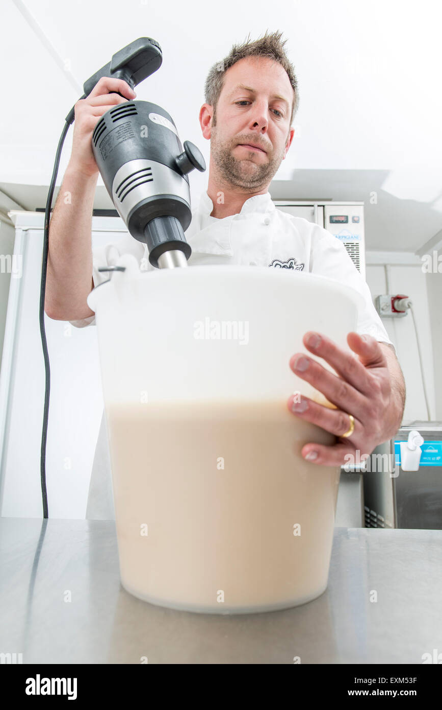 making ice cream in a professional kitchen, mixing it, adding the ...