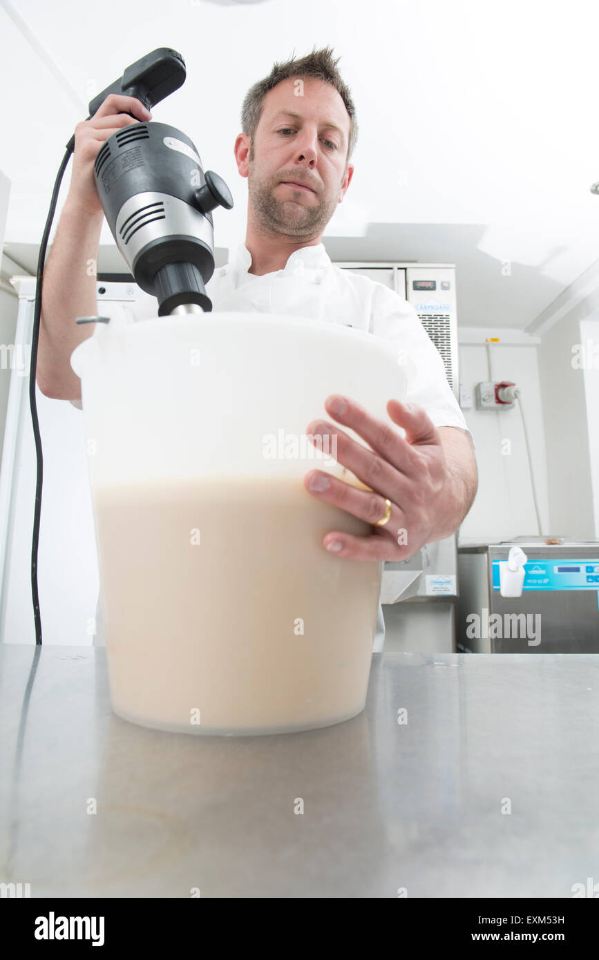 making ice cream in a professional kitchen, mixing it, adding the ...