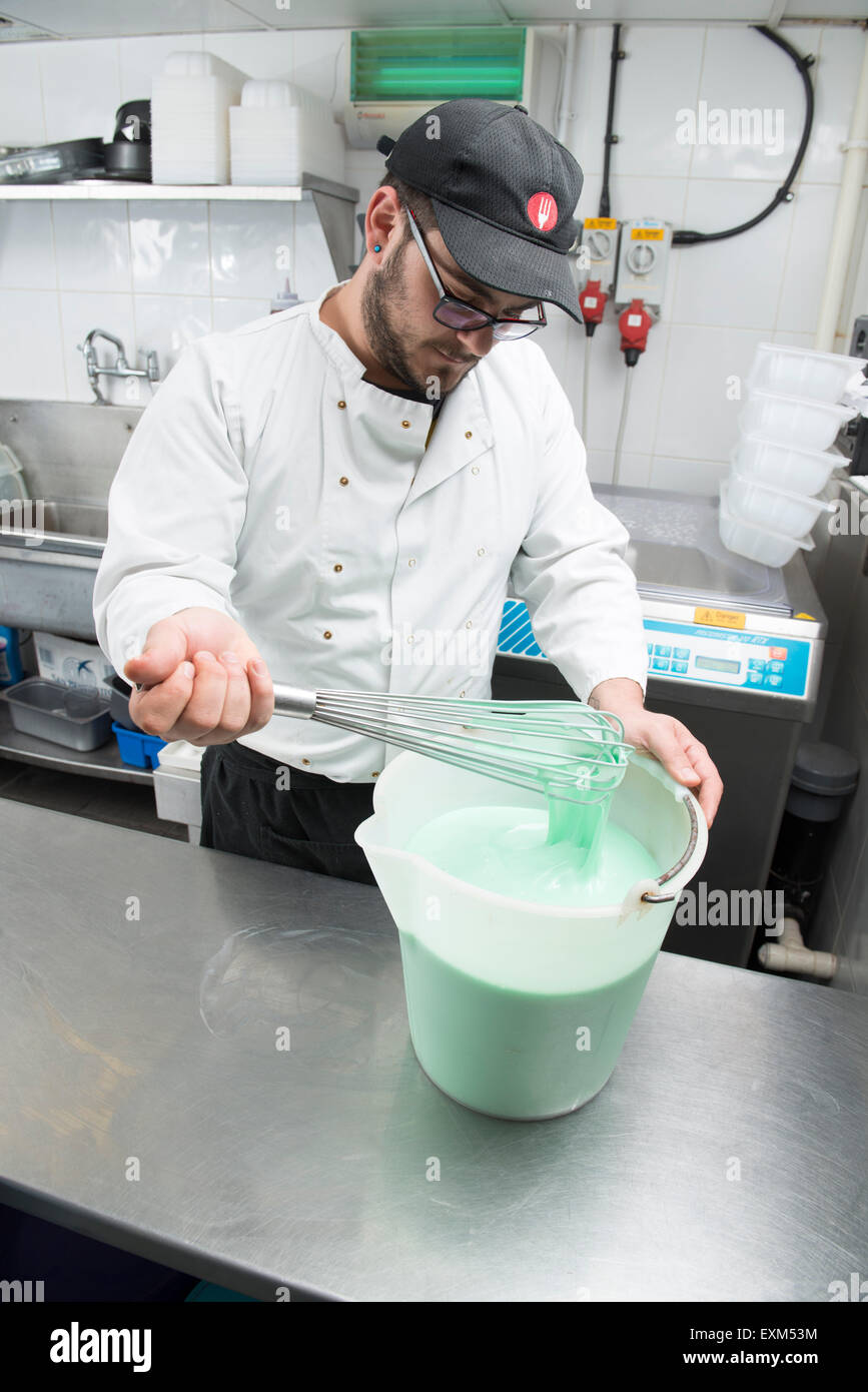 making ice cream in a professional kitchen, mixing it, adding the ...