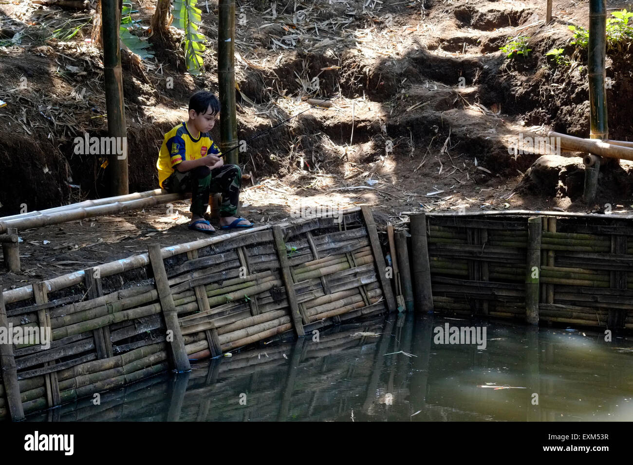 fishing indonesian style at a popular rural village man made pool near ...