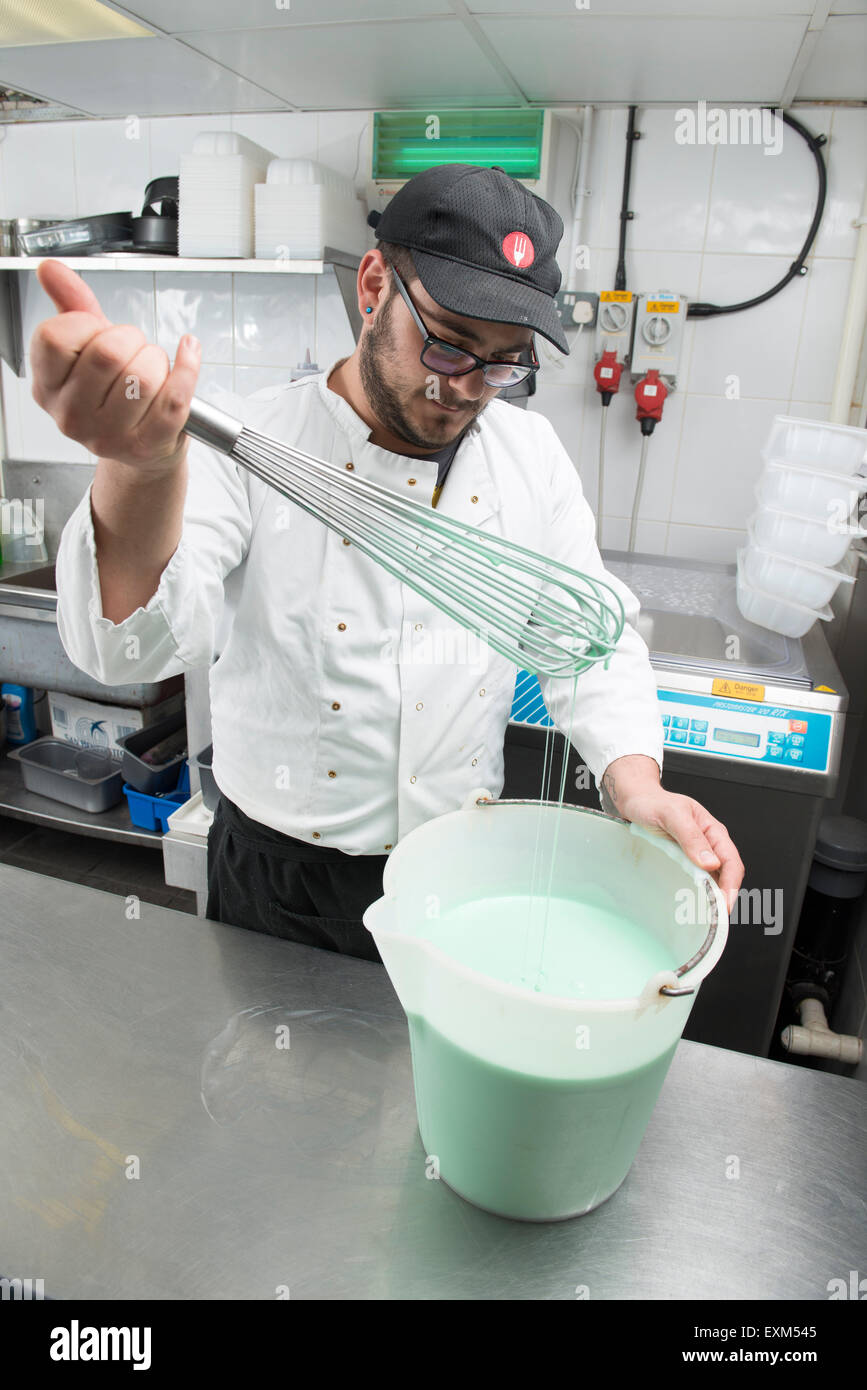 making ice cream in a professional kitchen, mixing it, adding the ...