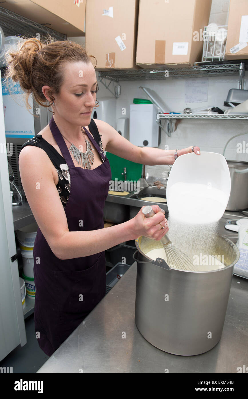 making ice cream in a professional kitchen, mixing it, adding the ...