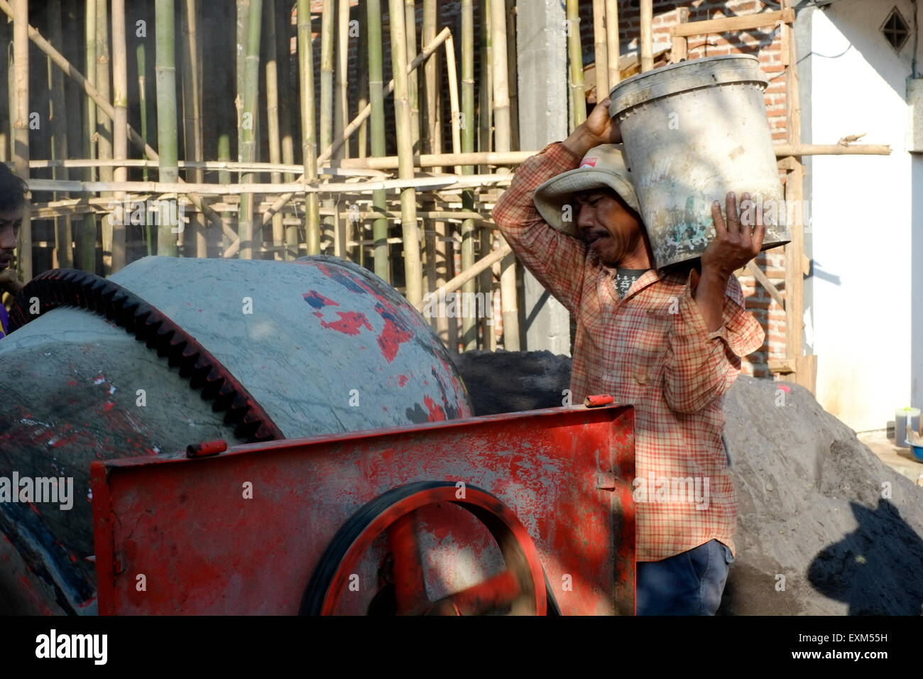 local villagers combine forces to work on the construction of a new ...