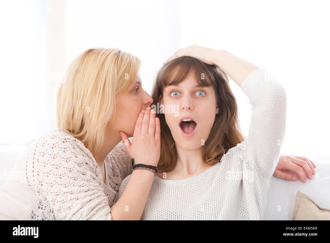 Telling a secret hi-res stock photography and images - Alamy