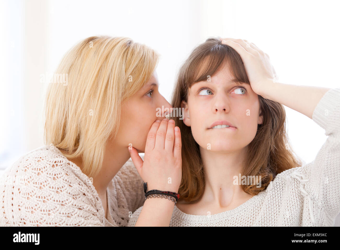 Two female friends sofa secret hi-res stock photography and images - Alamy