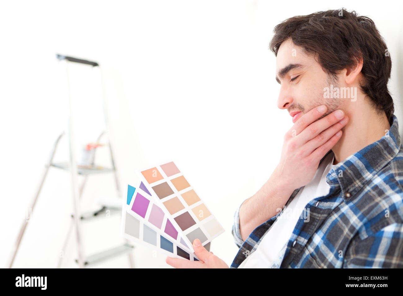 View of an Attractive man choosing the color of his new flat Stock ...