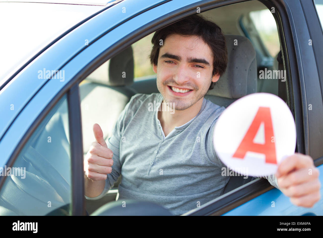 View of a young man happy to get his driving license Stock Photo - Alamy