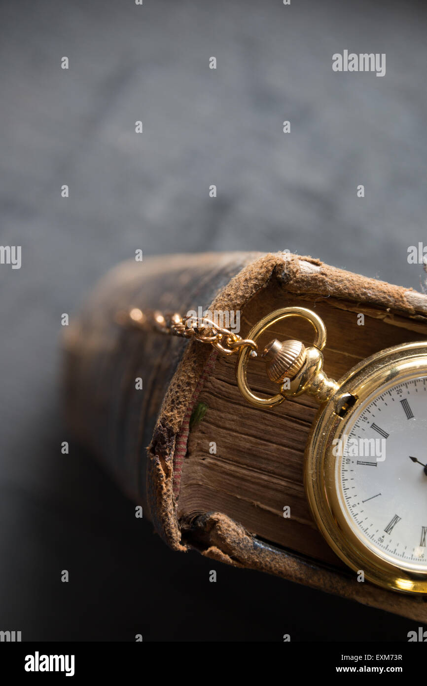 Vintage pocket watch and old book, symbols of time with copy space ...